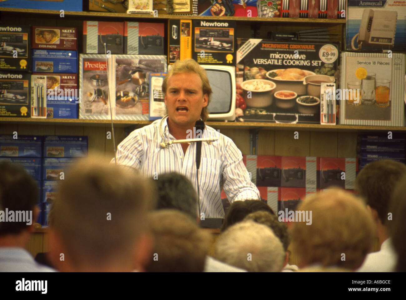 A market trader on a stall selling goods by auction Stock Photo - Alamy