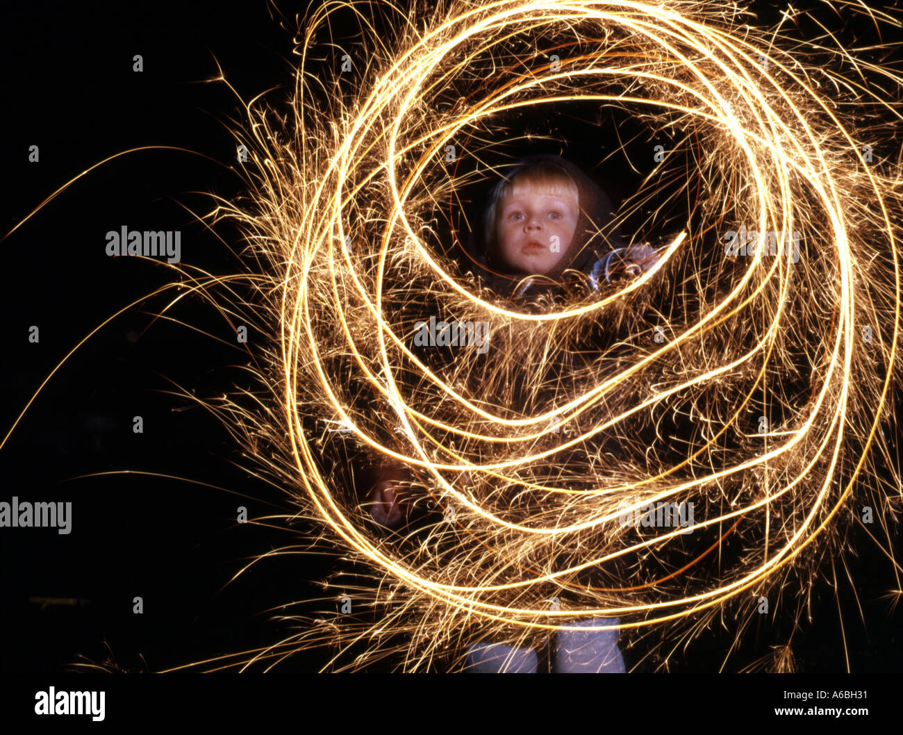 Young child with sparkler firework in the dark making trails Stock ...