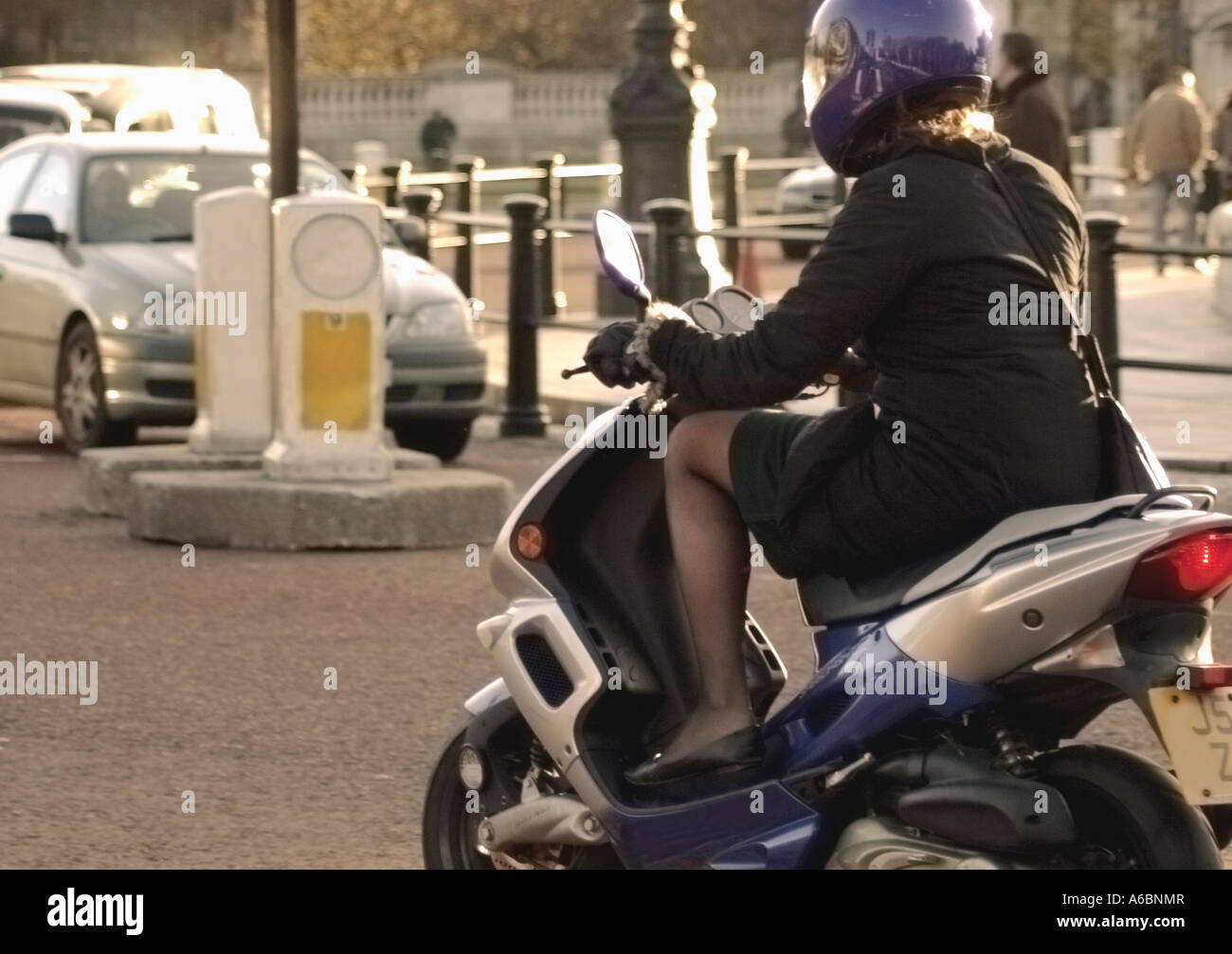 GIRL ON A SCOOTER. Smart female businesswoman, captured by roundabout ...