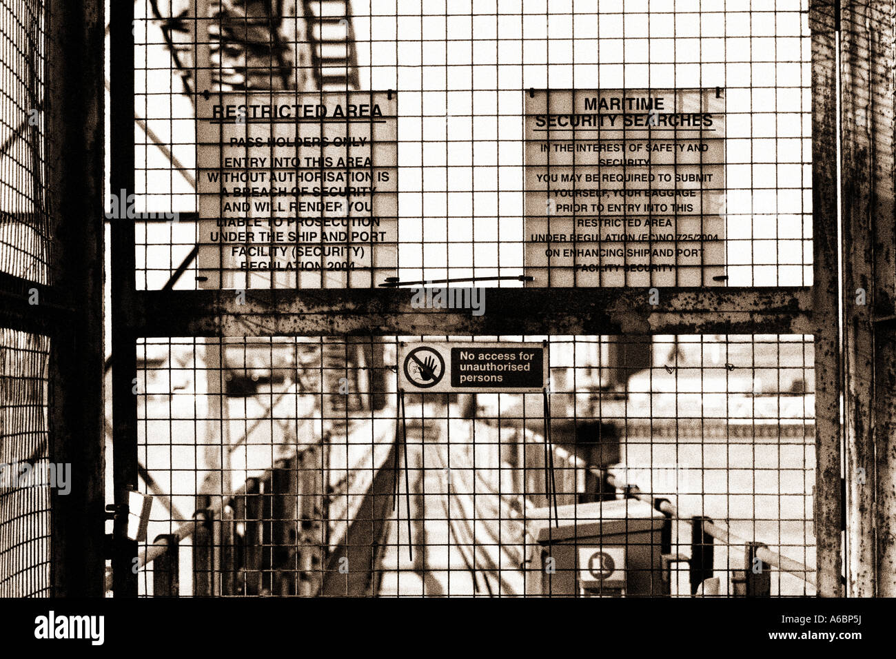 KEEP OUT. Closed-off river conveyor area. Image made sepia, dirtied-up ...