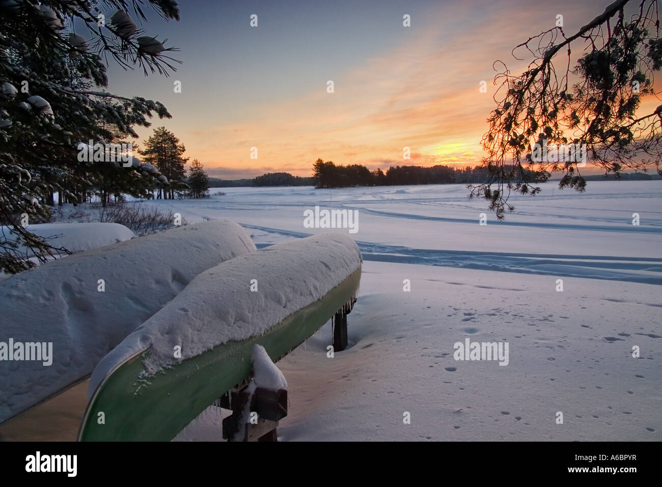 Upturned Canoe covered in snow at dawn Finland Stock Photo - Alamy