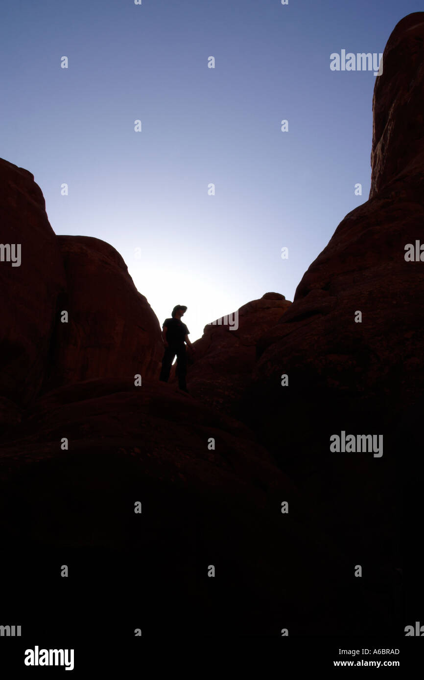 silhoutte of man standing on lowest point Stock Photo - Alamy