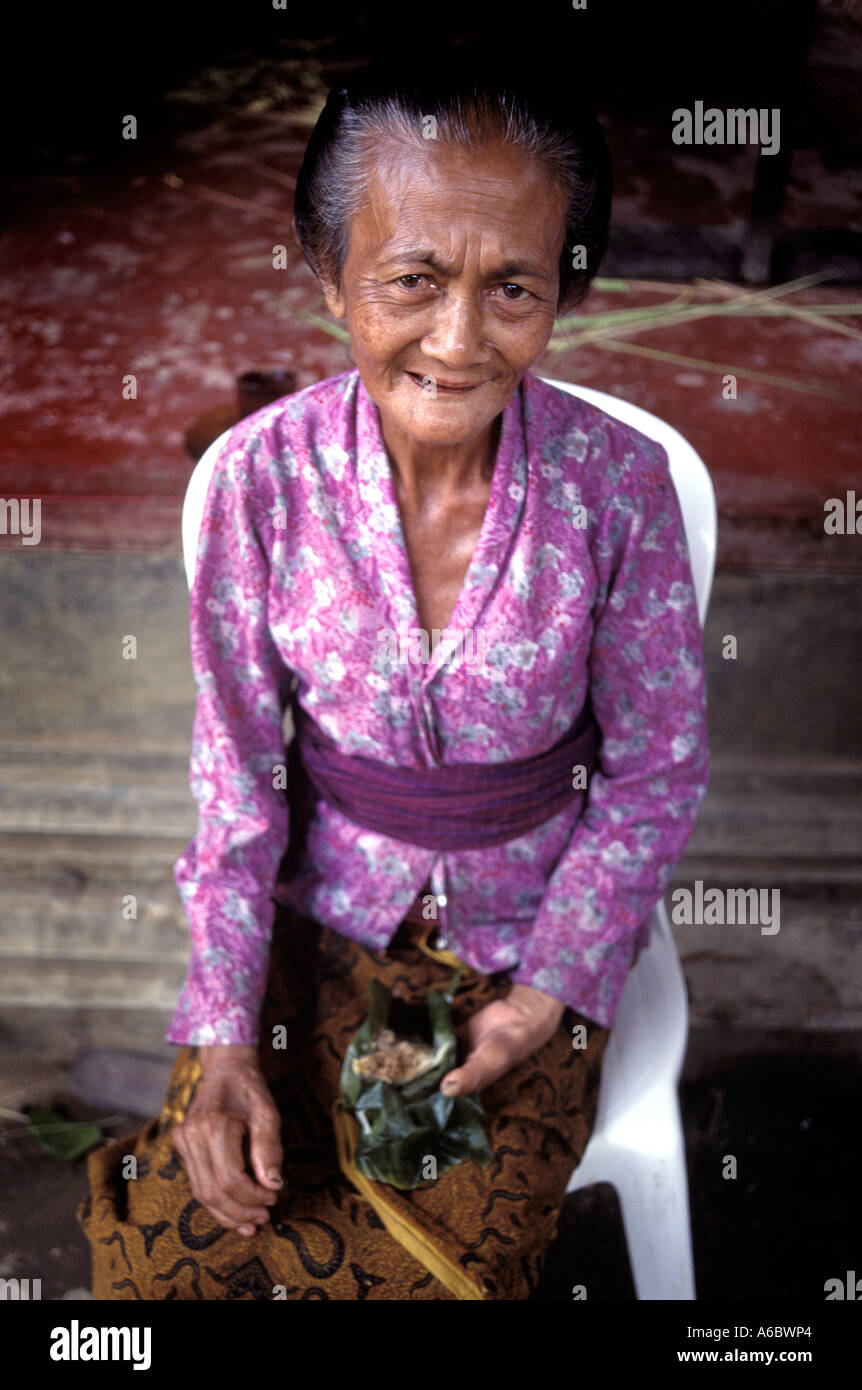 Old Balinese woman at a ceremony for the ritual blessing of a new ...