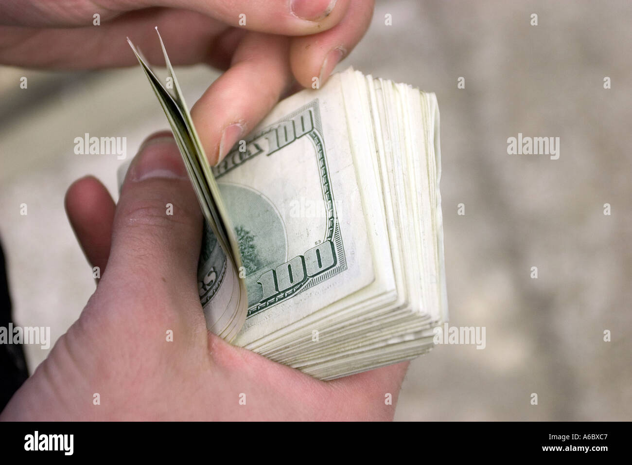 details of hand and fingers of man counting bundle of one hundred ...