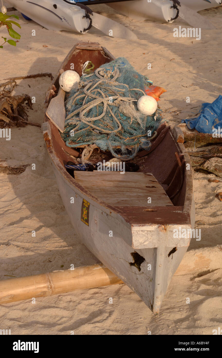 A color vertical image of an old canoe on a beach at sunset Stock Photo ...