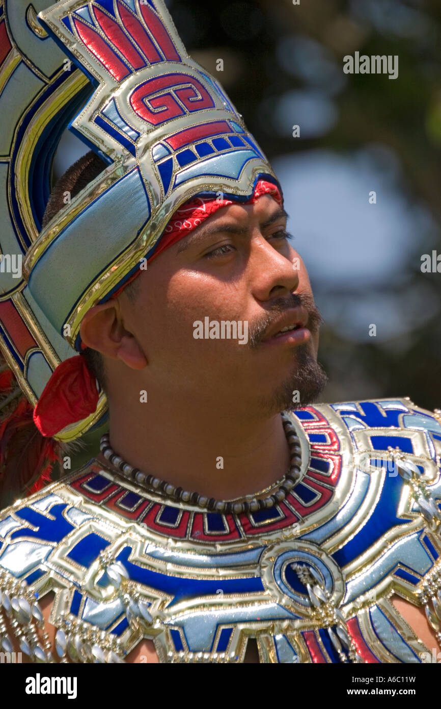 A handsome young man poses in traditional Aztec headdress at a cultural ...