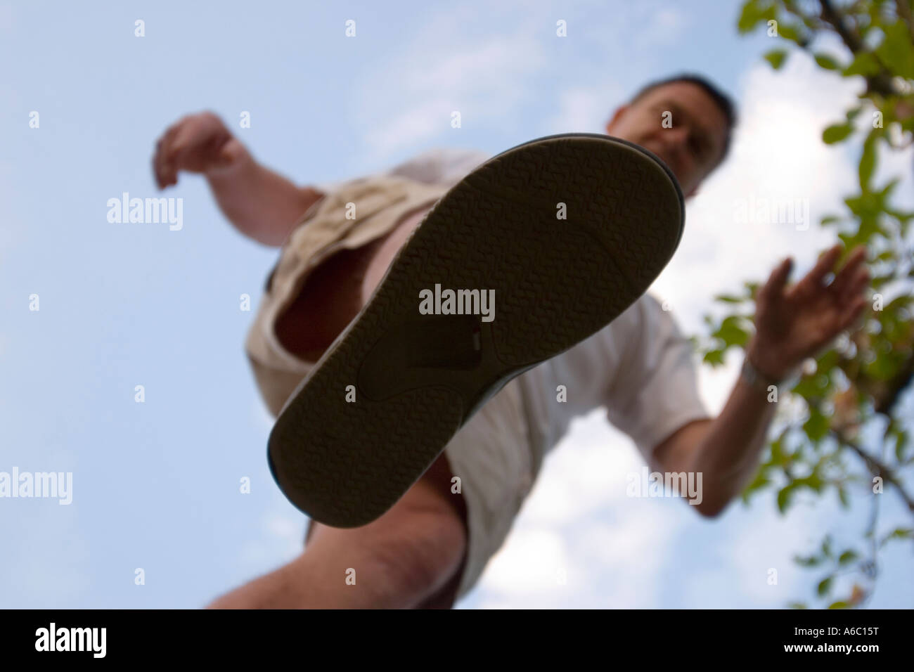 Funny image of a man about to step on something and flatten it with his ...