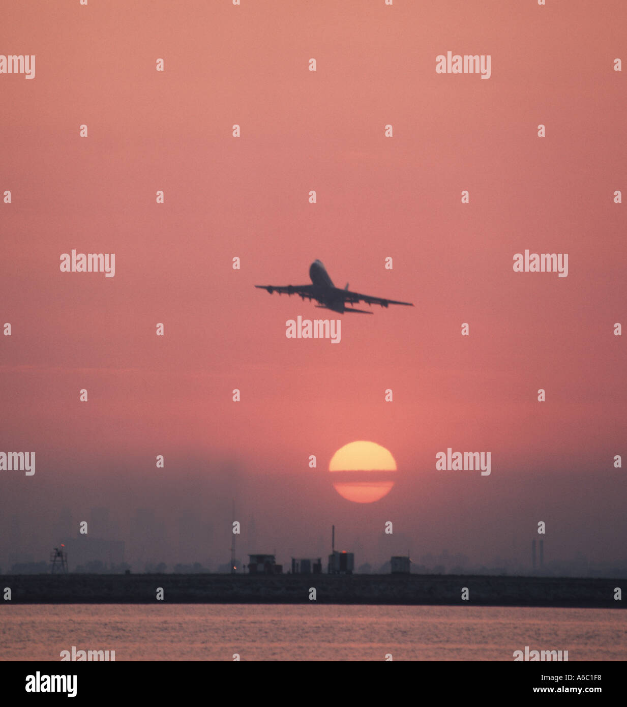commercial jet airplane taking off at sunset from New York Stock Photo ...