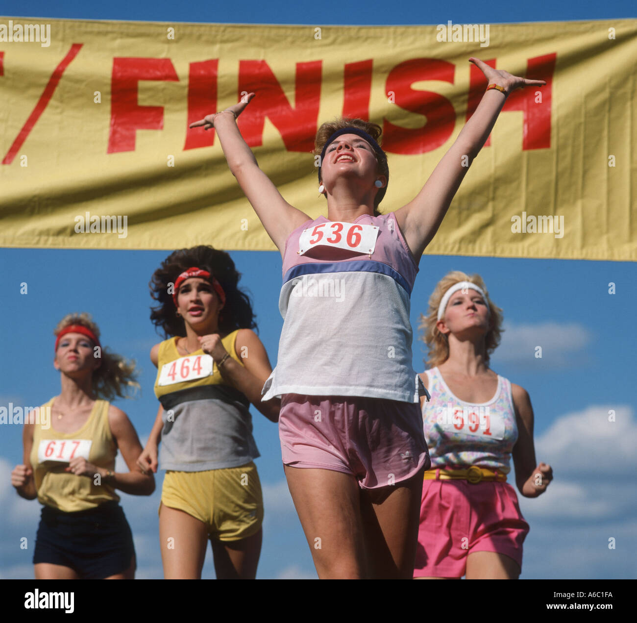 girl runner crosses finish line for first place win Stock Photo - Alamy