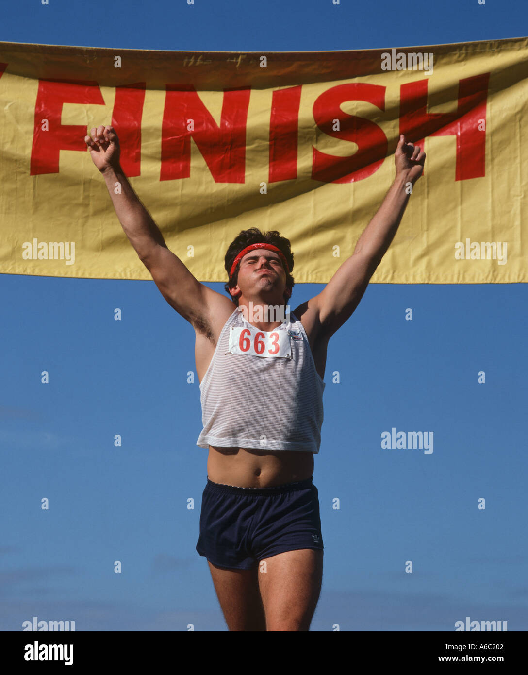 male runner crossing finish line at track meet race Stock Photo - Alamy
