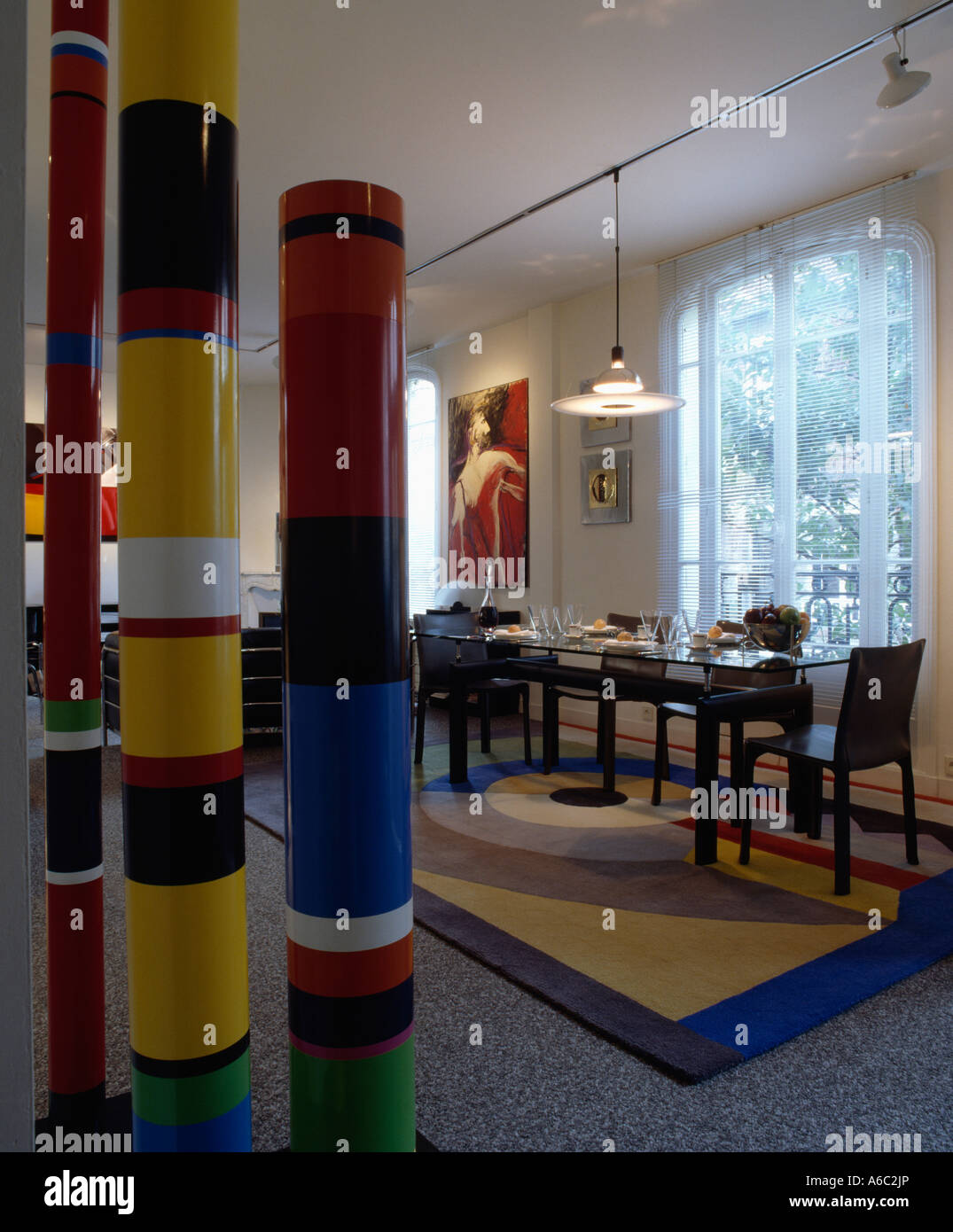 Multi-colored striped pillar sculptures in modern diningroom with black ...