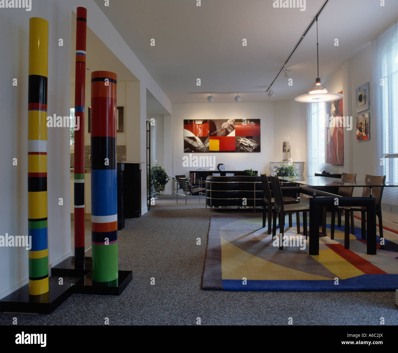 Multi-coloured striped pillars in eighties dining and living room with ...