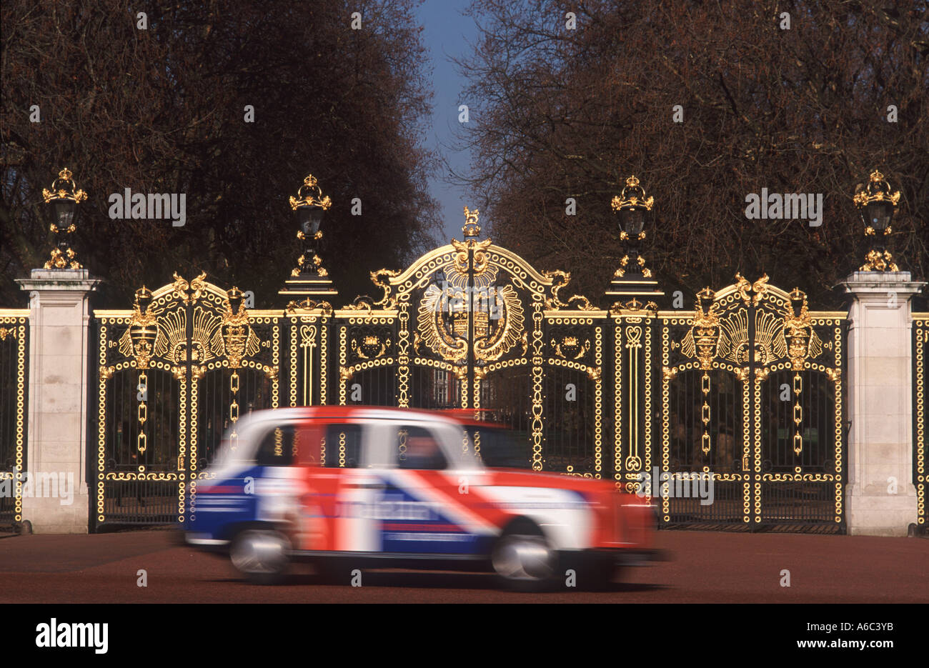 Union Jack painted London cab in blurred motion passing gold and black ...