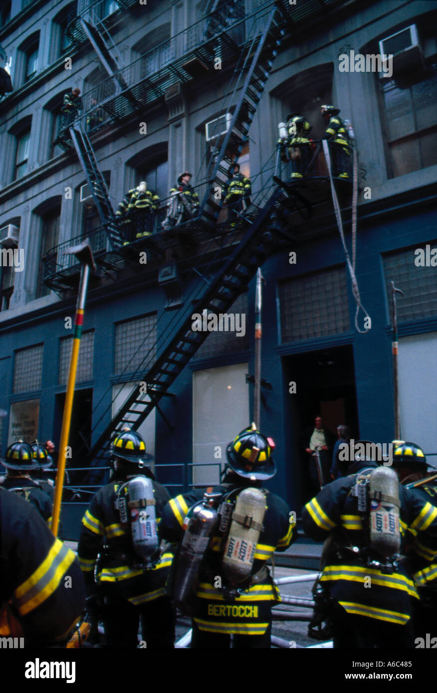 2760 New York Fire Fighters entering building by fire escape Stock ...