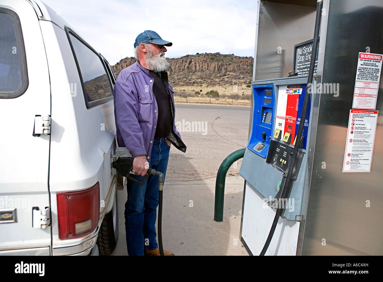 Man pumping gas at a station in West Texas Stock Photo - Alamy