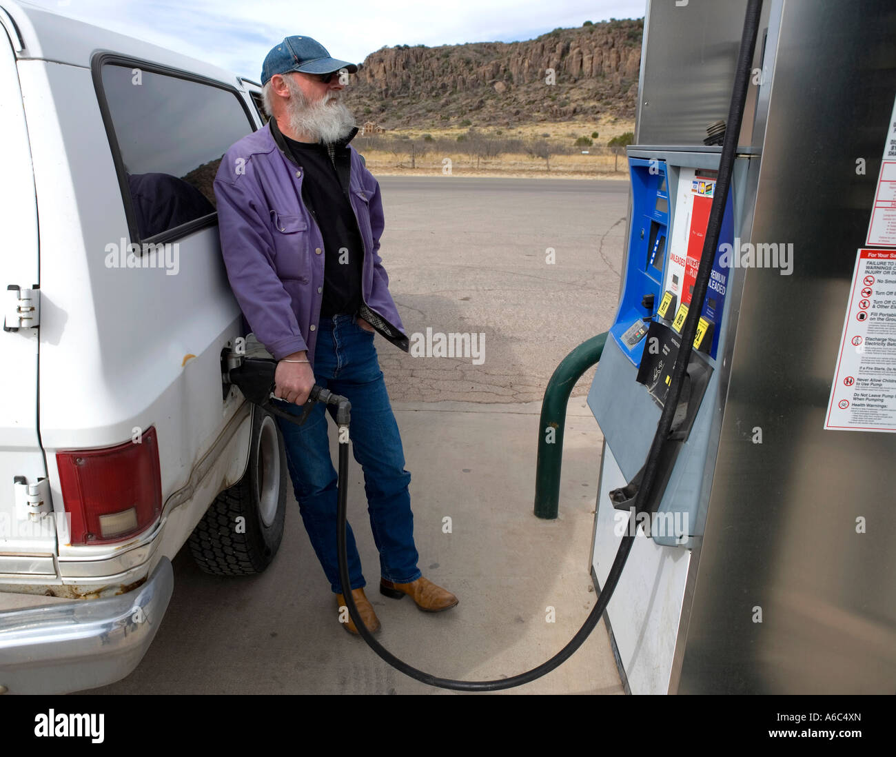 Man pumping gas at a station in West Texas Stock Photo - Alamy