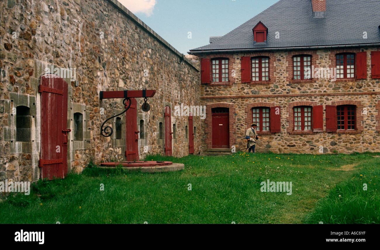 A soldier crosses a courtyard in the reconstructed 18th century fort of ...