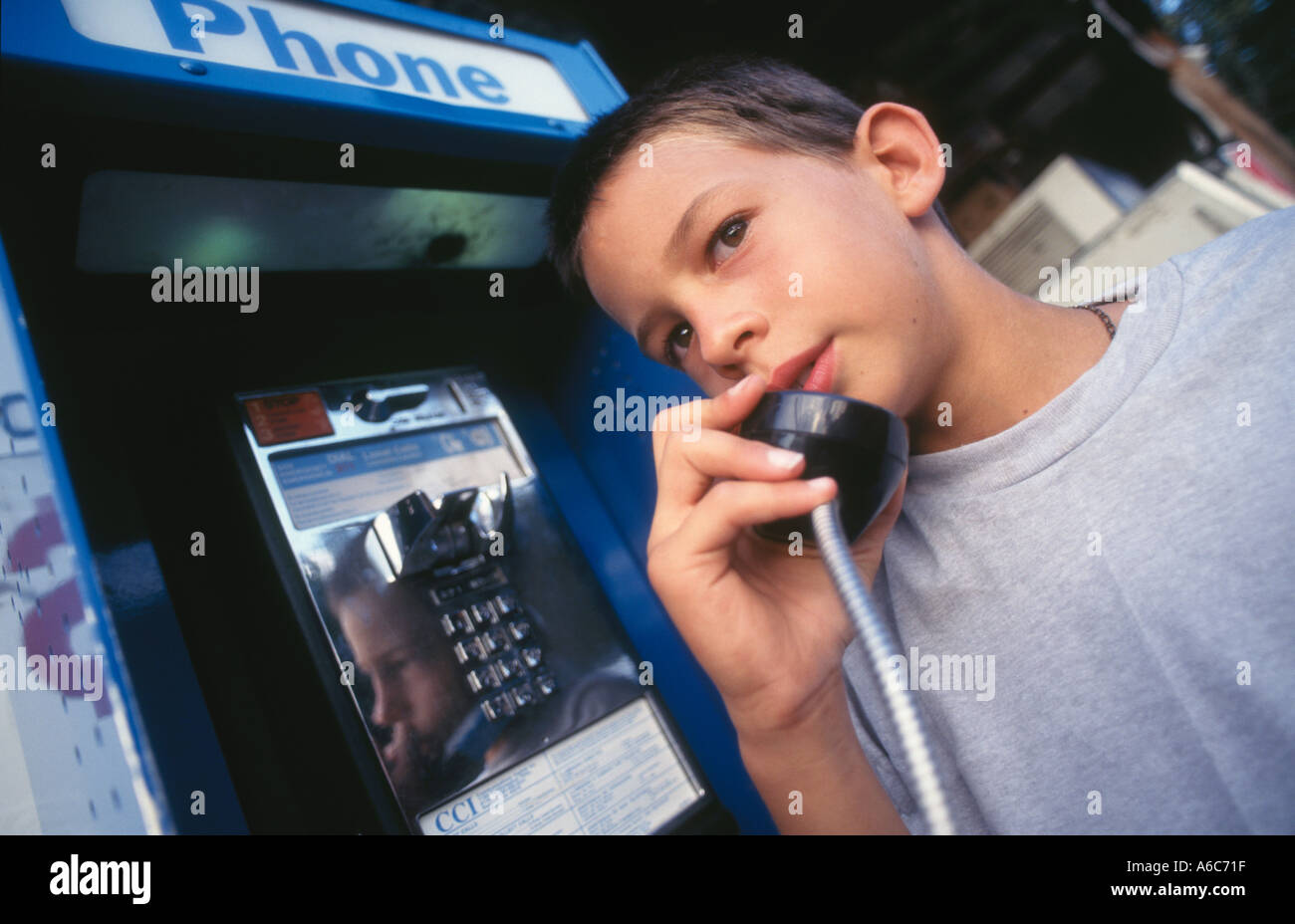 boy middleschool boy talking on pay telephone Stock Photo - Alamy
