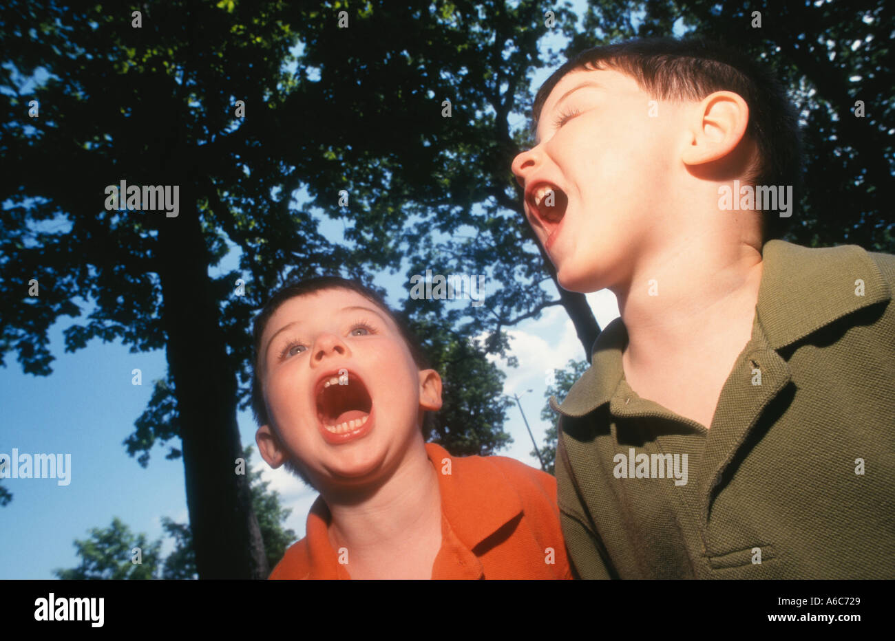 young boys twin boys playing outside screaming happy laughing Stock ...