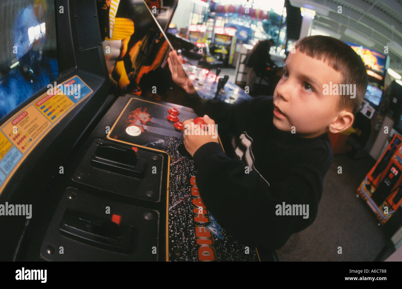 young boy playing play video game arcade Stock Photo - Alamy