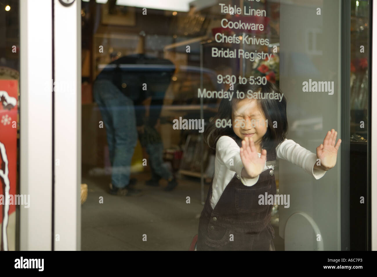 Child pushing store door open Stock Photo - Alamy