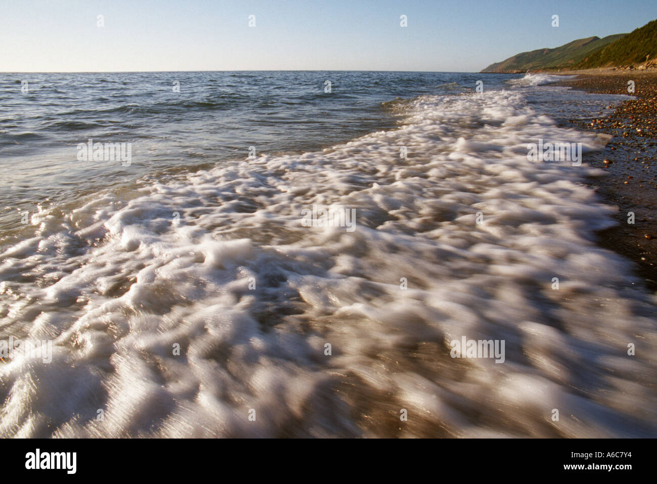 Waves rushing up the beach Stock Photo - Alamy