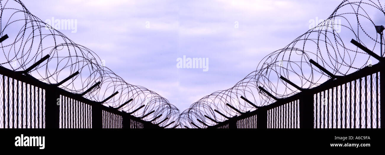 fence fence post spike barb barrier Stock Photo - Alamy