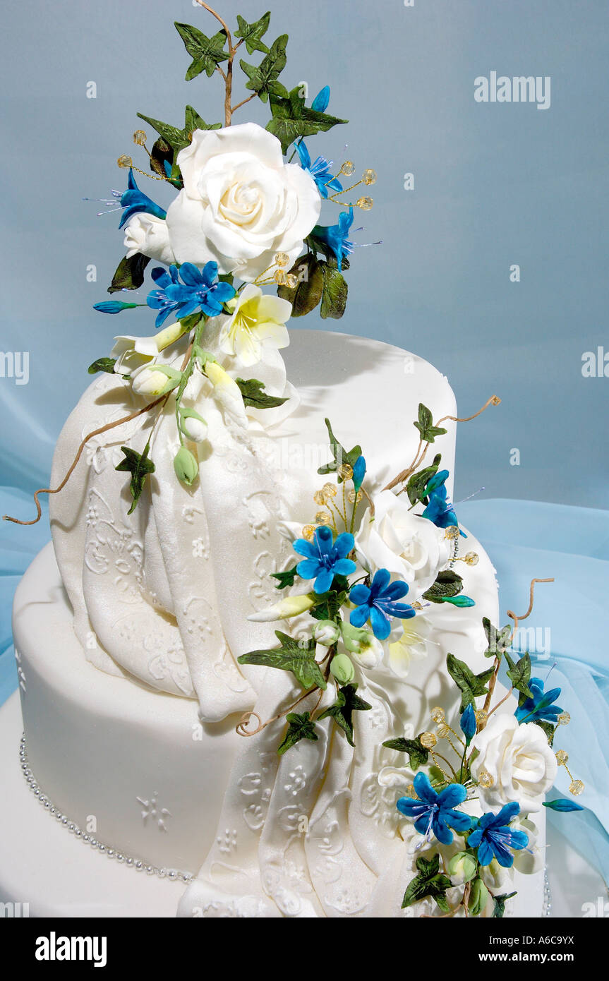 Beautifully crafted hand decorated three tier stacked wedding cake in a ...