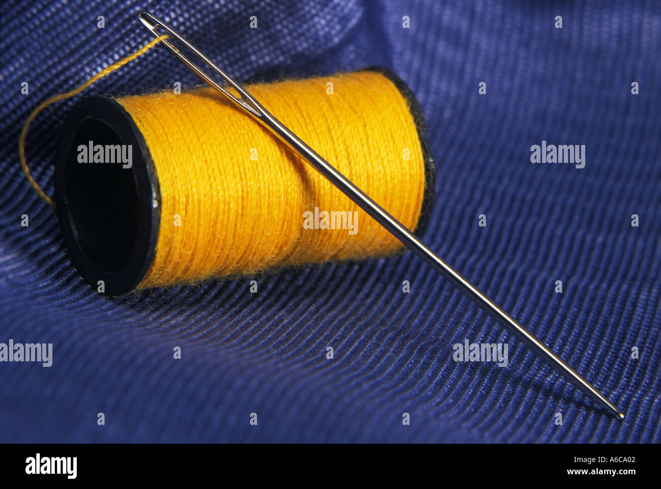 needle and reel of cotton thread Stock Photo - Alamy