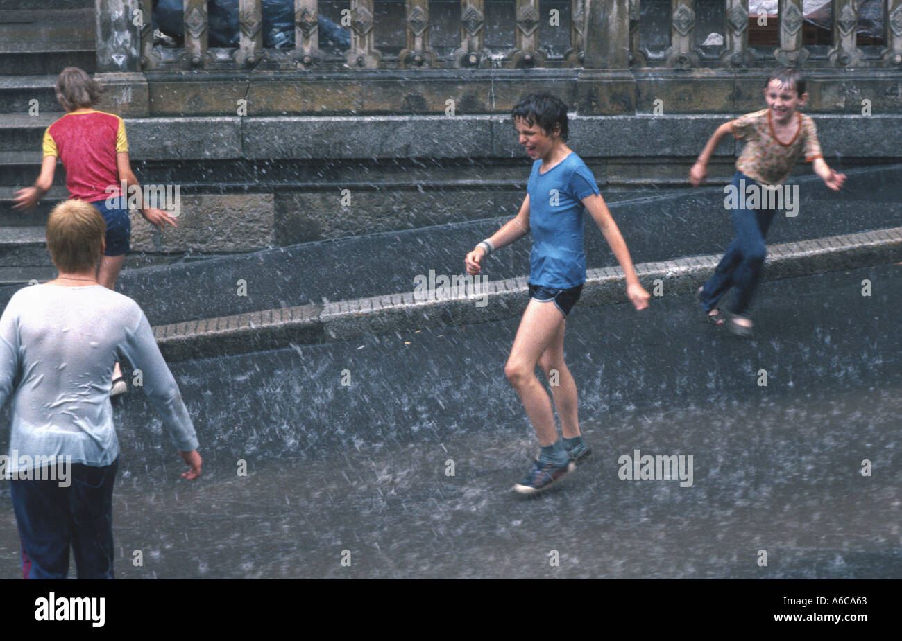 Children playing running rain hi-res stock photography and images - Alamy