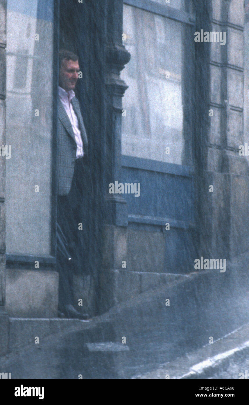 rainy day underneath dry place door street wet water waiting man Stock ...