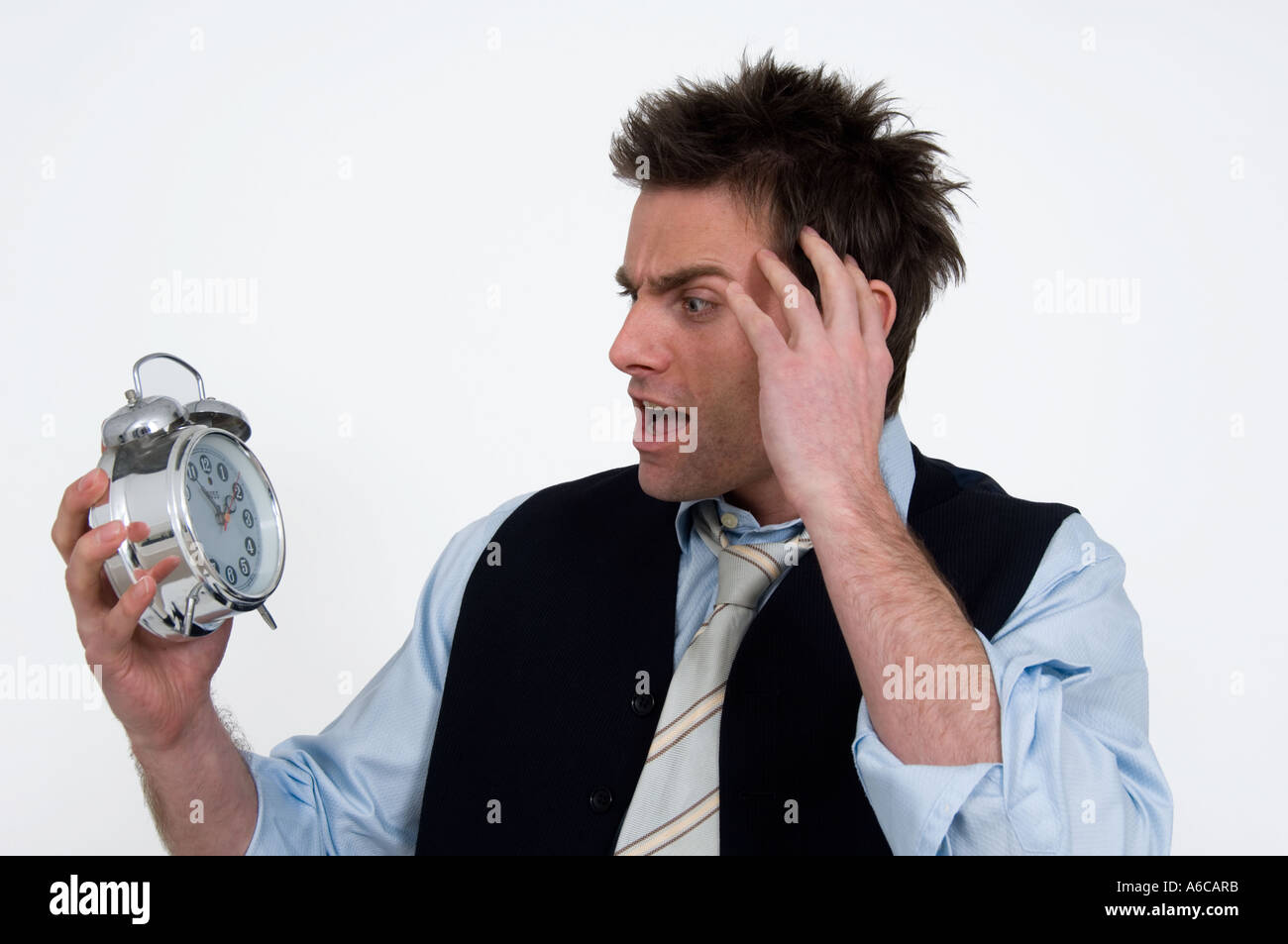 stressed businessman looking at an alarm clock businessman looking ...