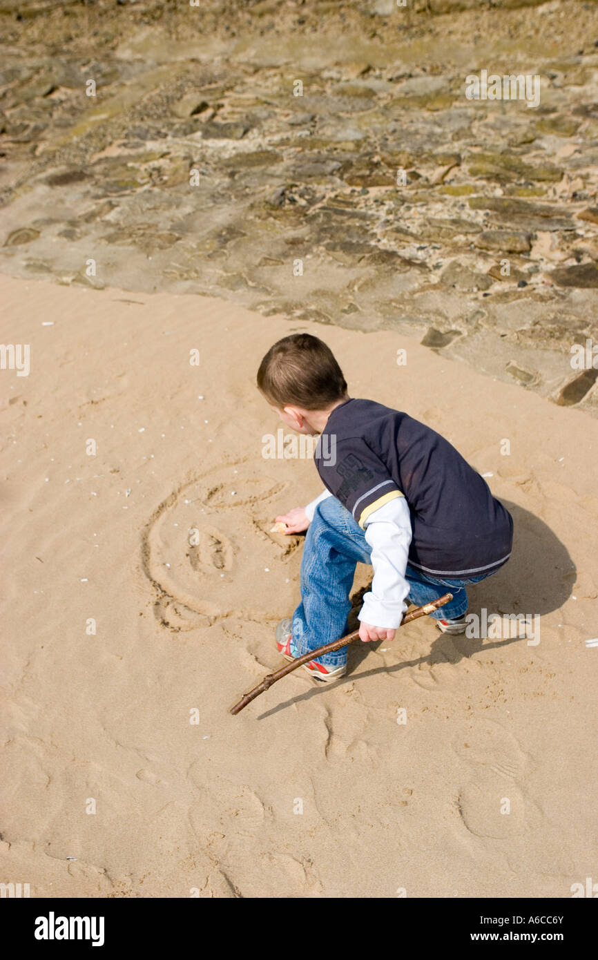 Boy Drawing In Sand Stick High Resolution Stock Photography and Images ...