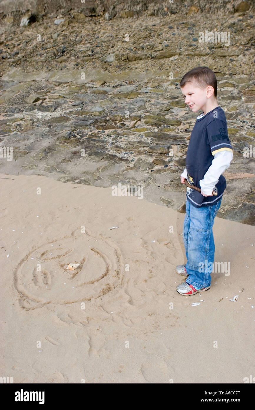 Boy Drawing In Sand Stick High Resolution Stock Photography and Images ...