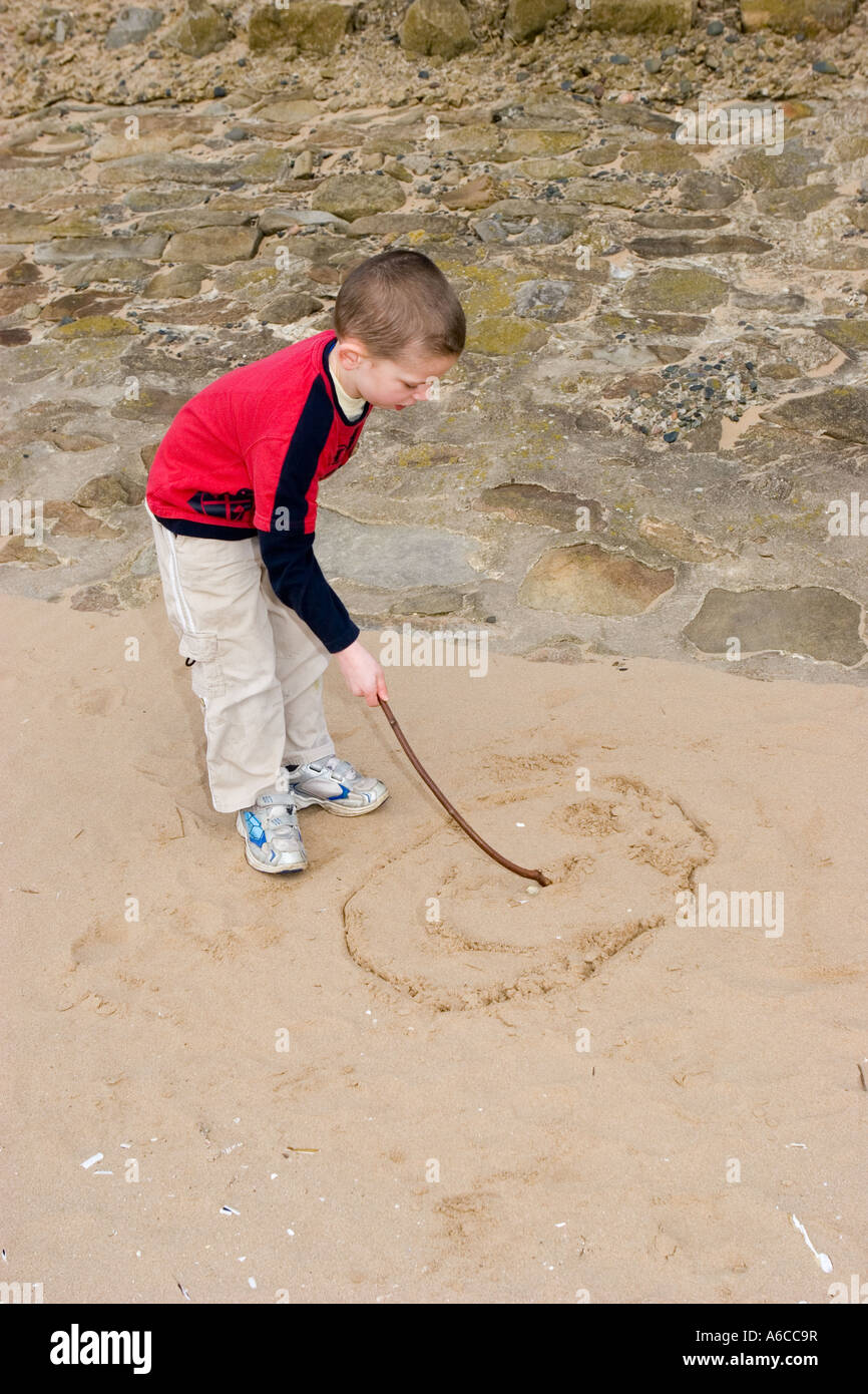 Boy Drawing In Sand Stick High Resolution Stock Photography and Images ...
