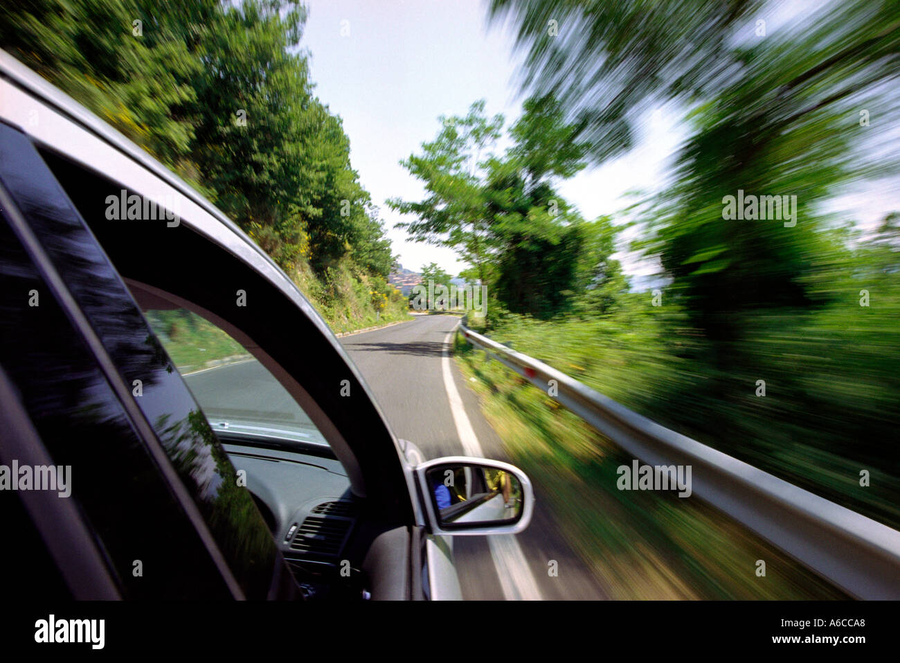 Car approaching S Bends on country road Stock Photo - Alamy