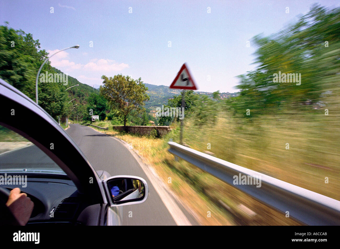Car approaching S Bends on country road Stock Photo - Alamy