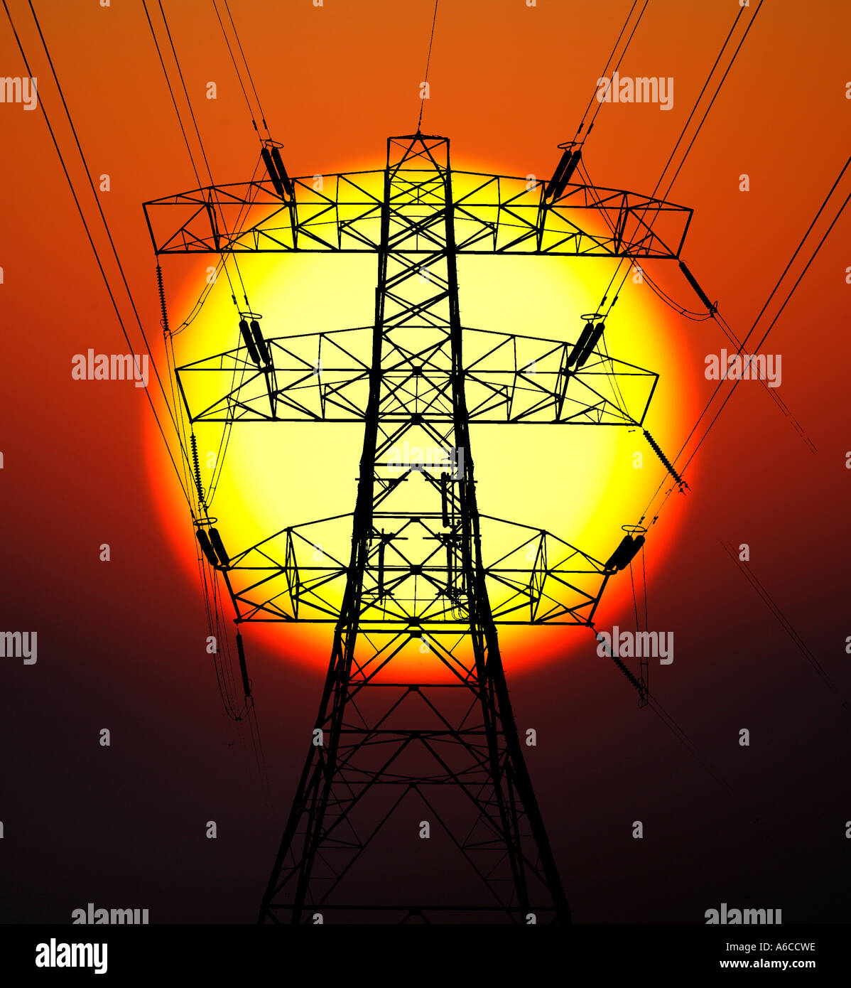 A High Voltage Pylon against a Glowing Sun Stock Photo - Alamy