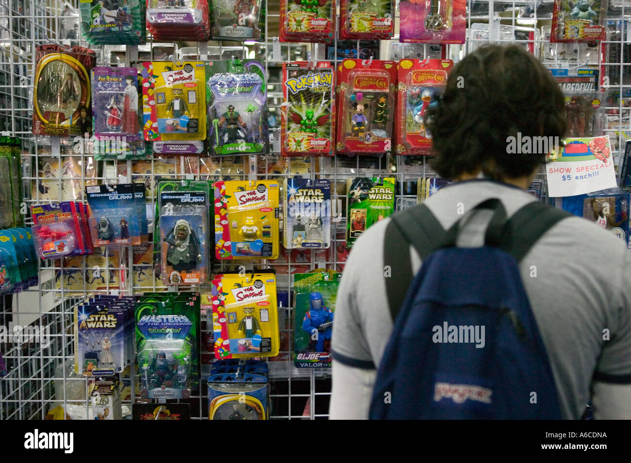 A visitor examines cartoon characters on sale at the Comic Con comics ...