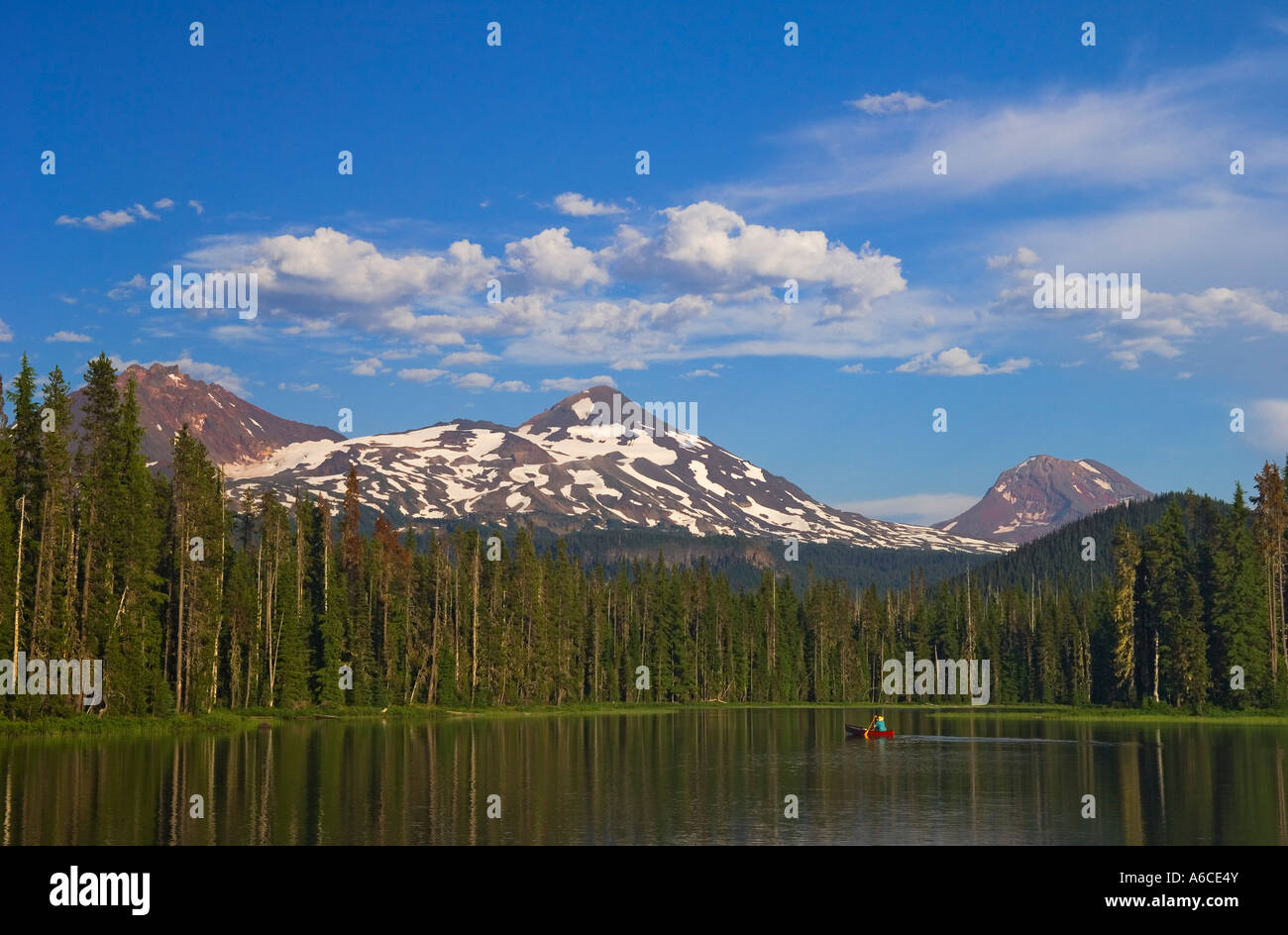 Scott Lake and the Three Sisters volcanic mountain peaks with man ...
