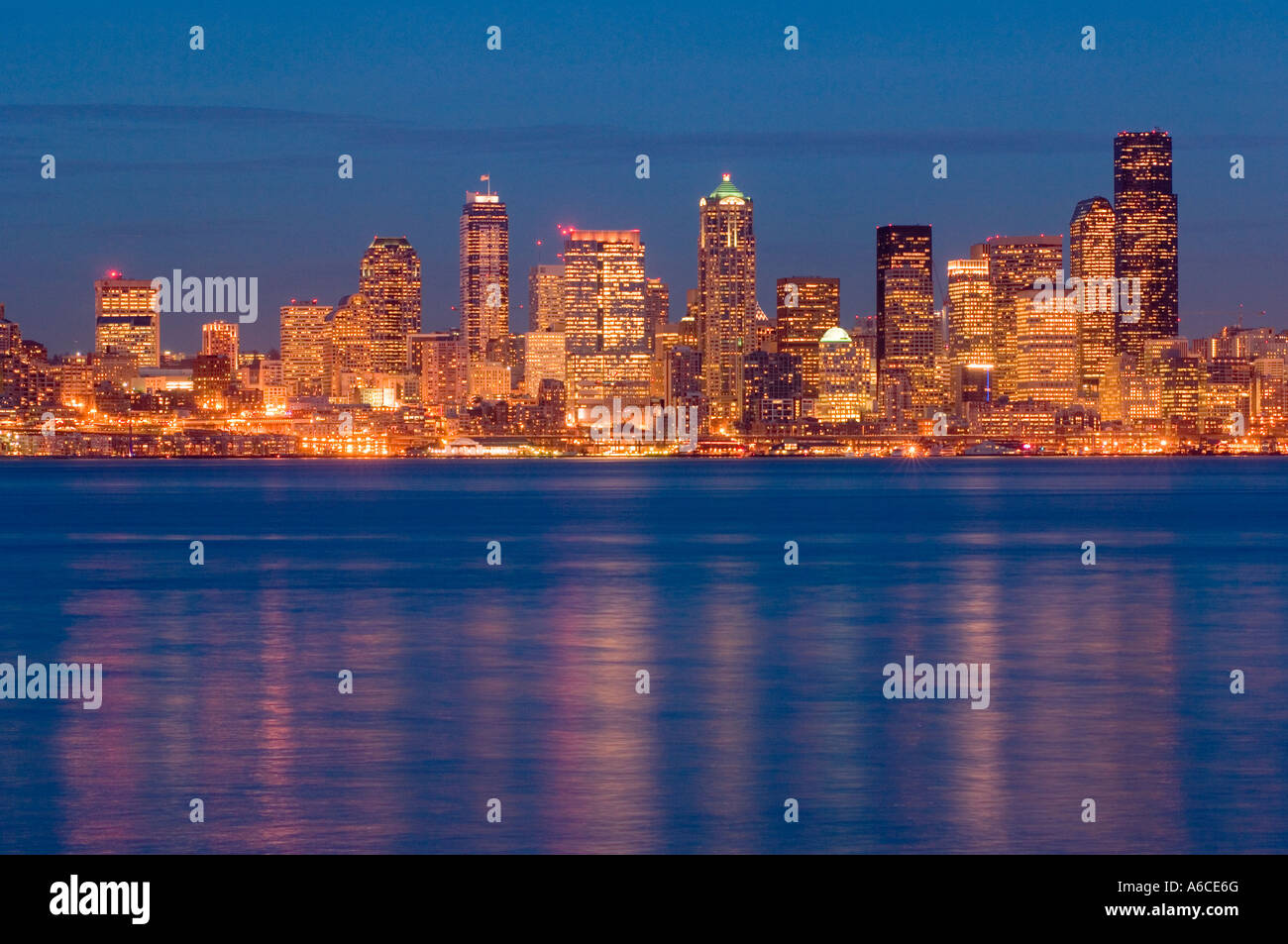 Downtown Seattle Washington cityscape and Elliot Bay at night from Alki ...