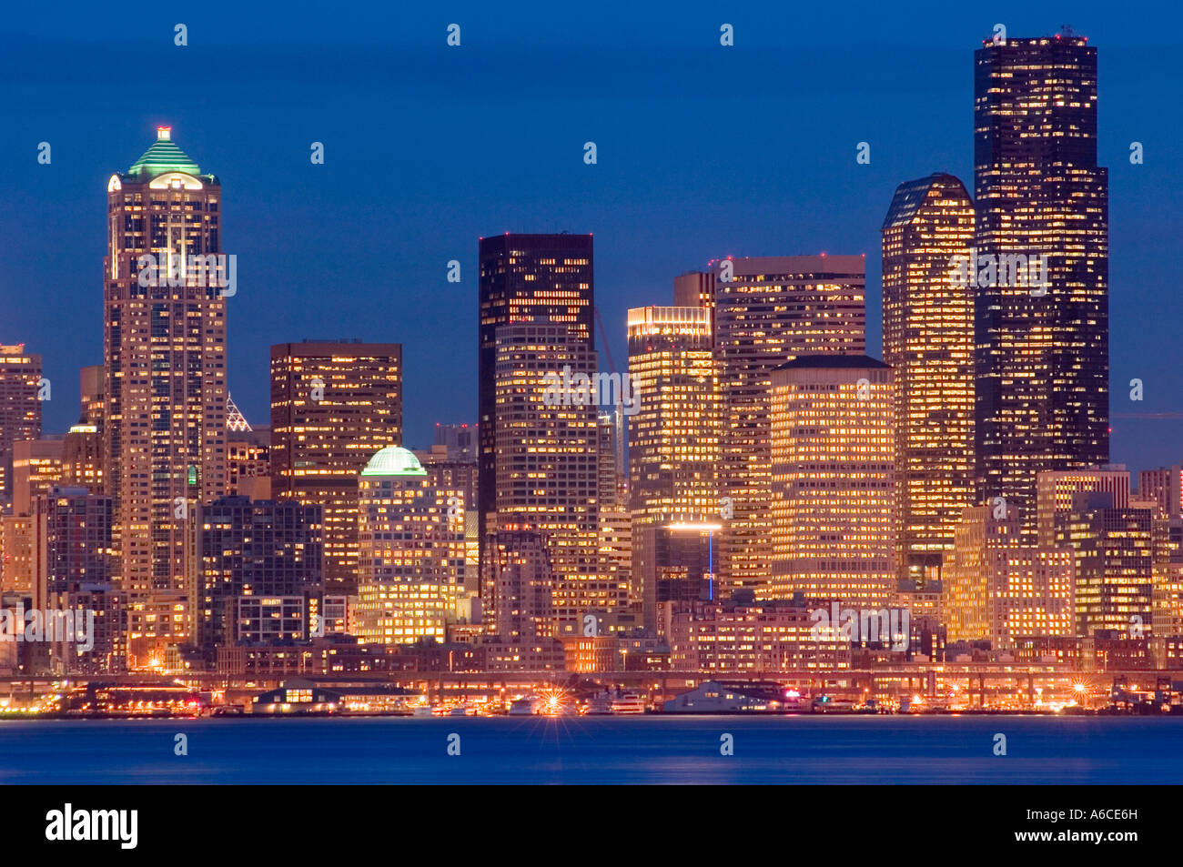 Downtown Seattle Washington cityscape and Elliot Bay at night from Alki ...