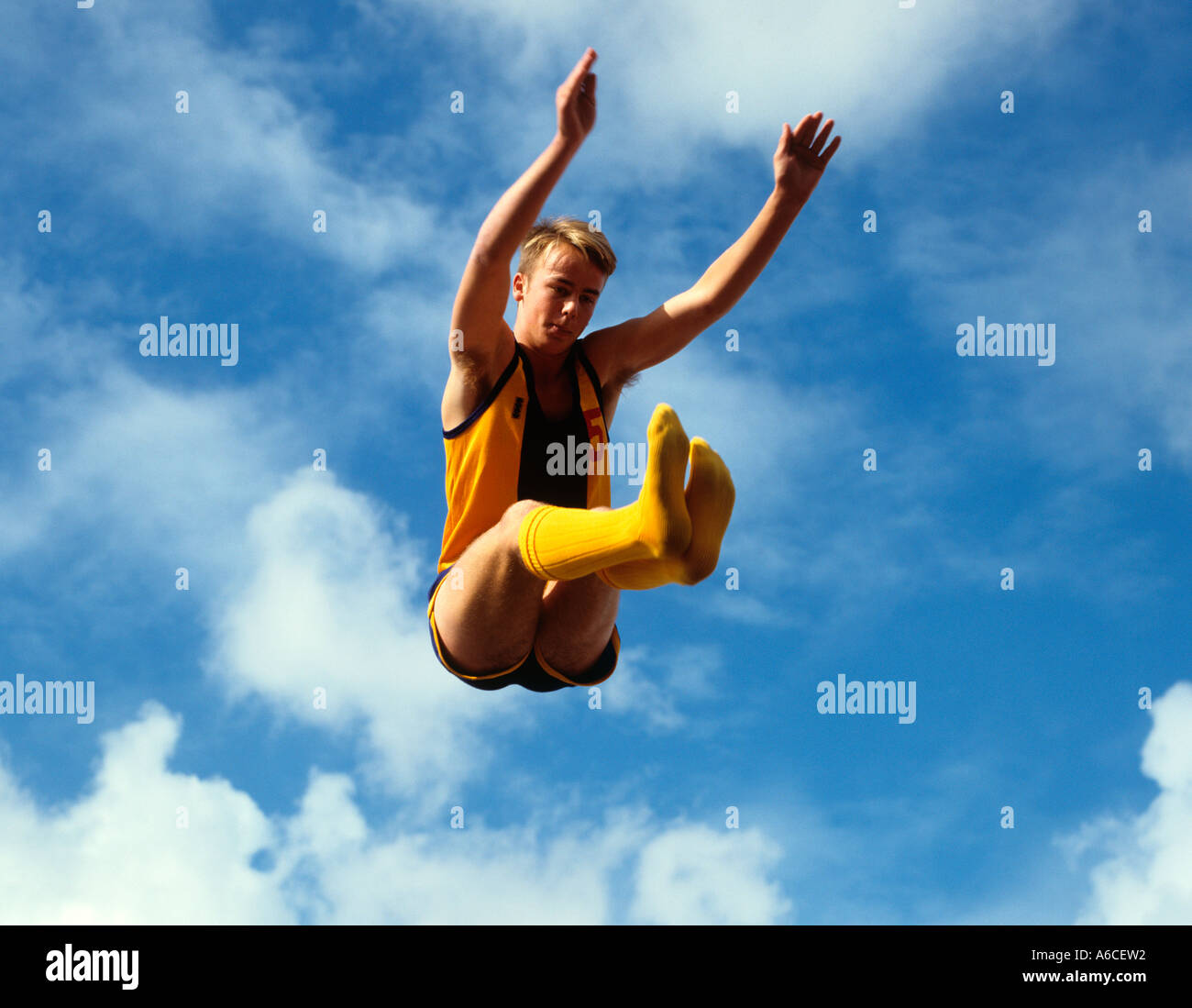 Sport school student in air during long jump Stock Photo - Alamy