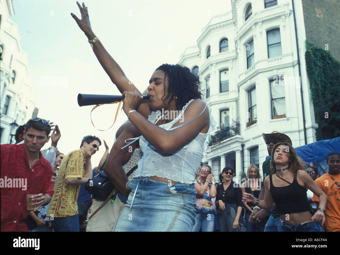 Girl dancing and blowing her horn Notting Hill Carnival London Stock ...