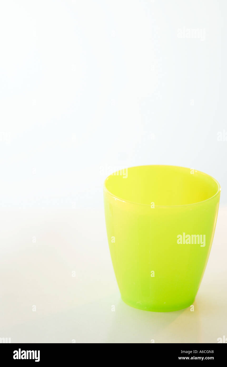 Green plastic glass on white background Stock Photo - Alamy