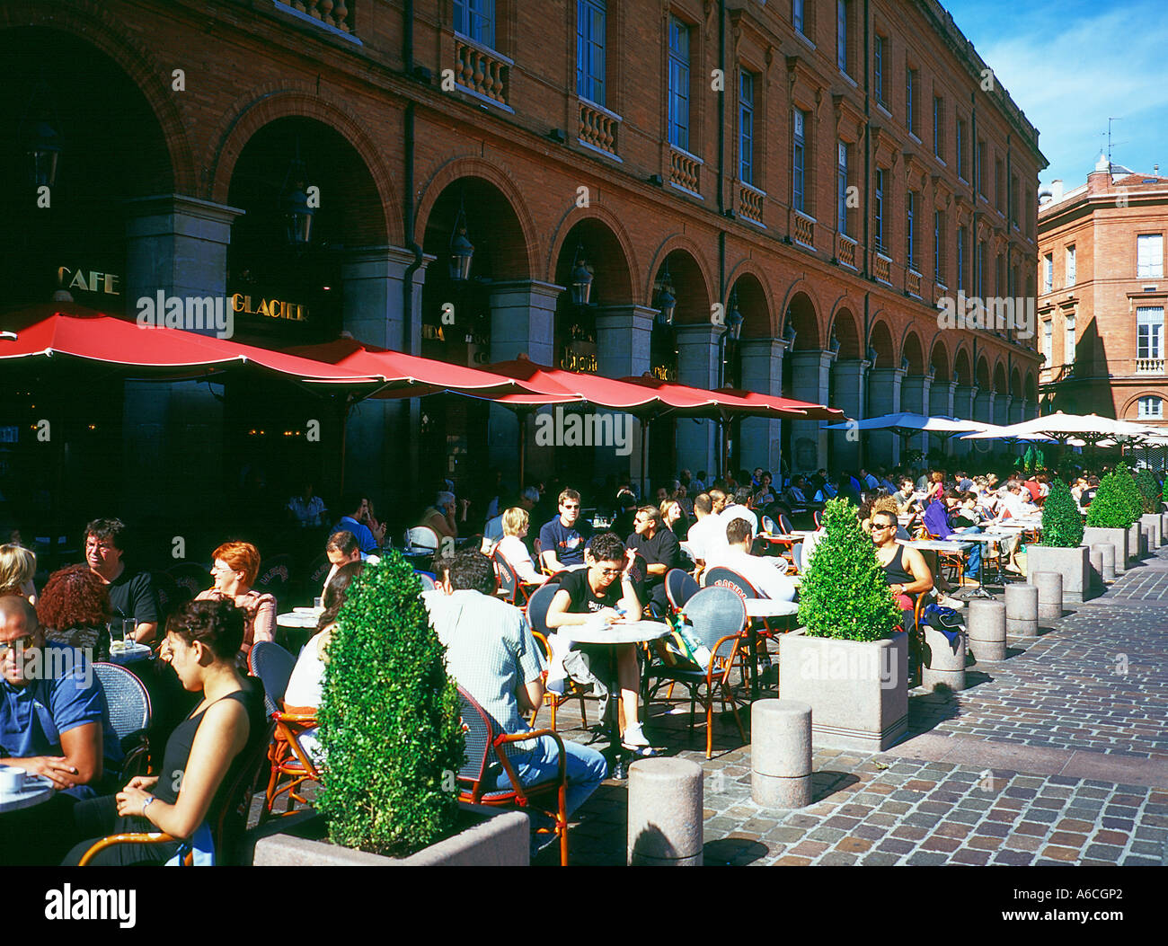 people sitting outside cafe bars in the 'place du capitole' toulouse ...