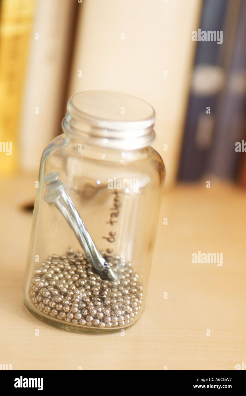 Nails in glass bottle Stock Photo - Alamy