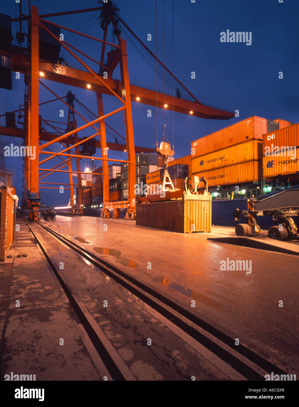 Cargo ship loading and unloading containers at freight terminal ...