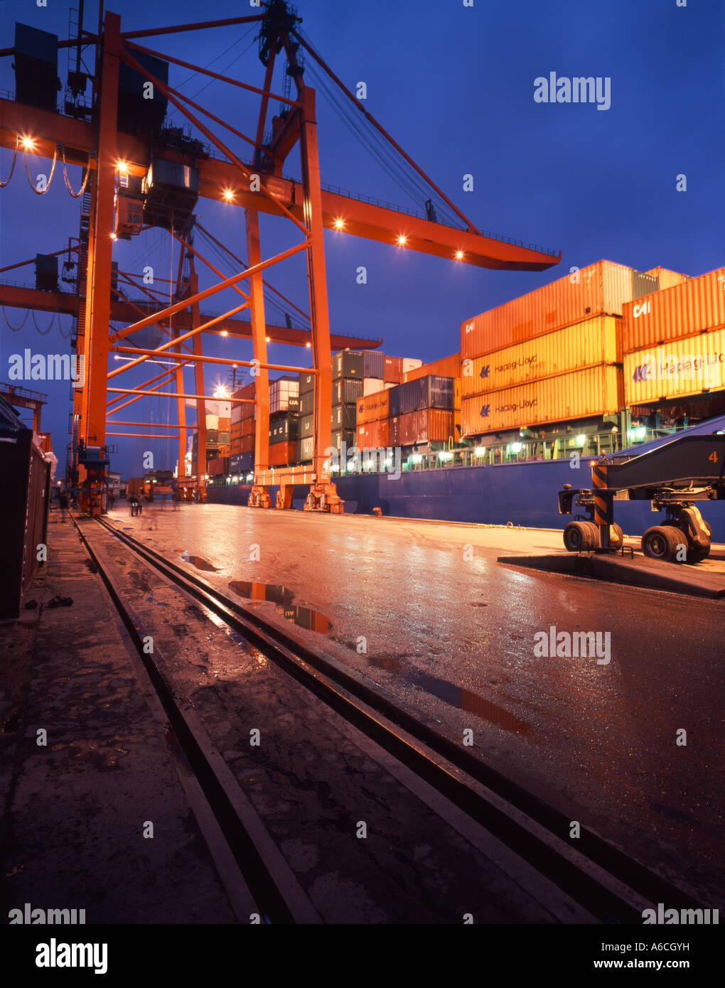 Cargo ship loading and unloading containers at freight terminal ...