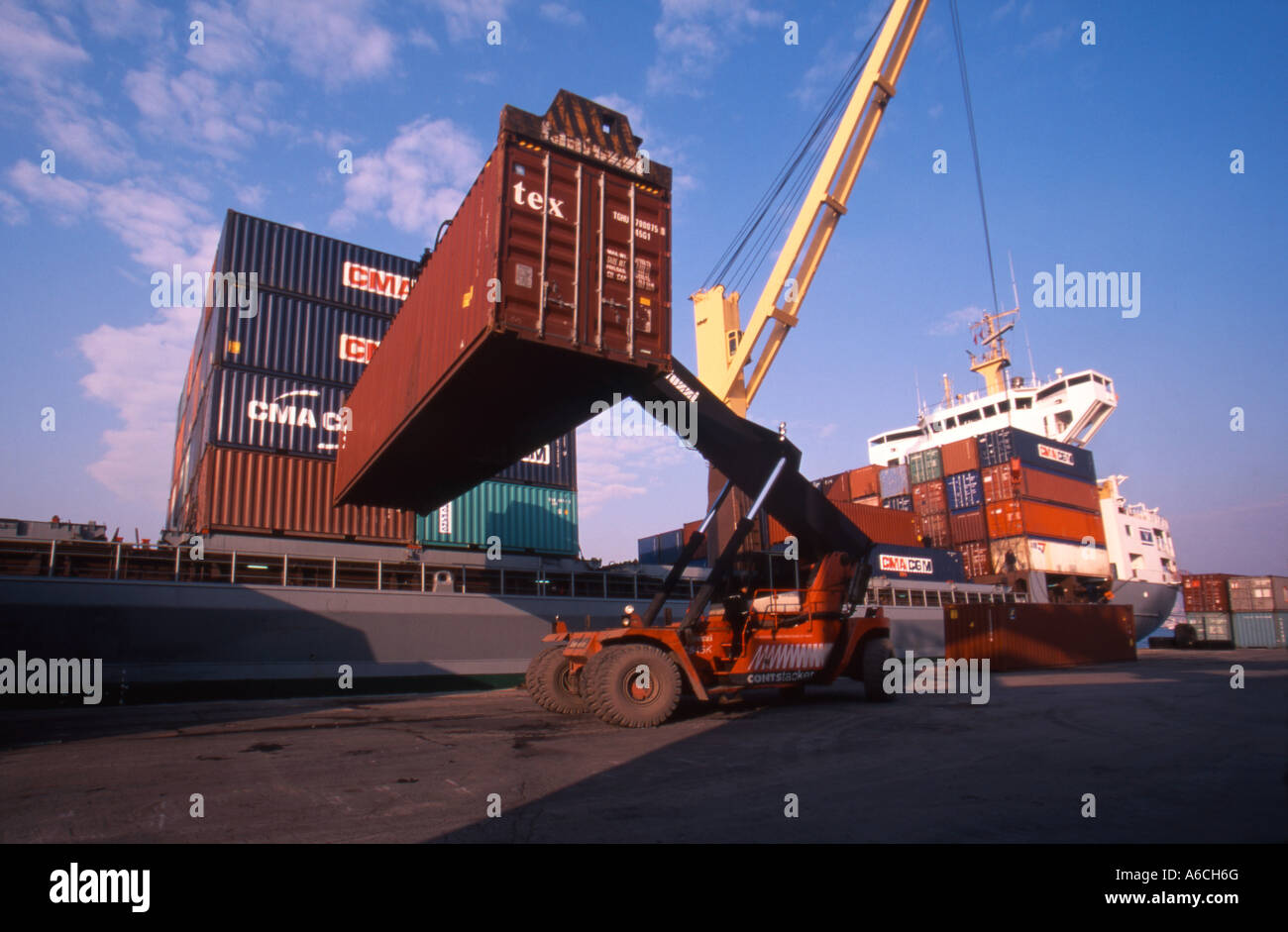 Stacker vehicle lifting container at freight terminal Istanbul Turkey ...
